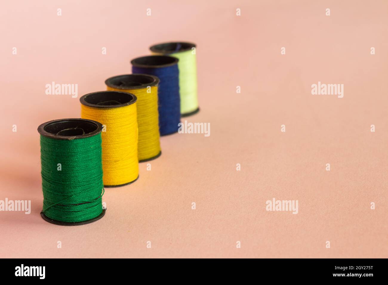 Spool or spools of colored threads on a neutral background. Free space ...