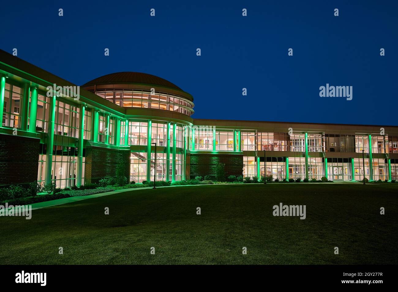 Front view of a dormitory at a university with green lighting the ...