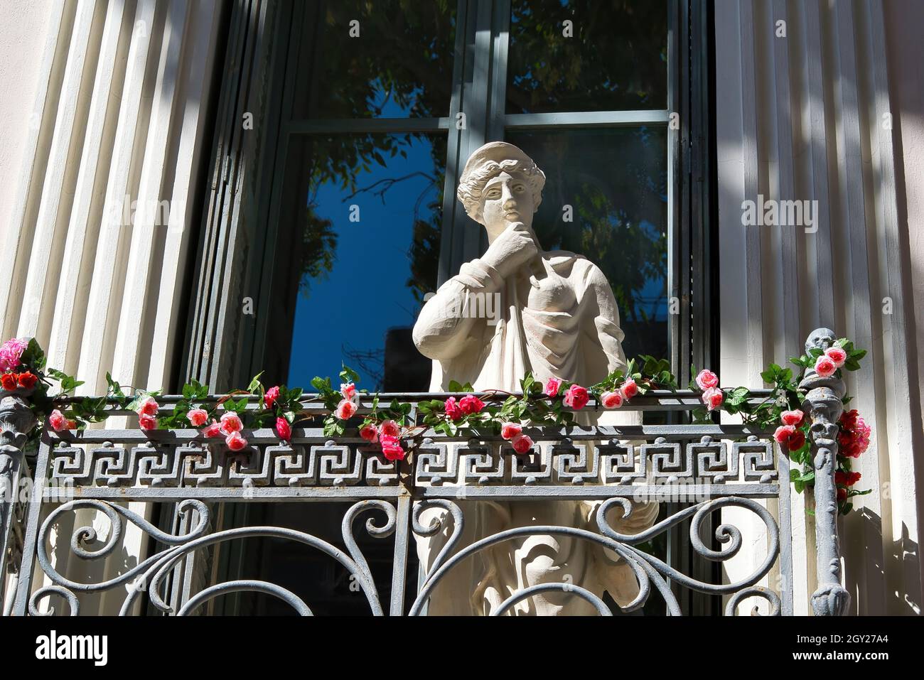 Balcony with flowers and a sculpture of a lady in Athens, Greece Stock ...