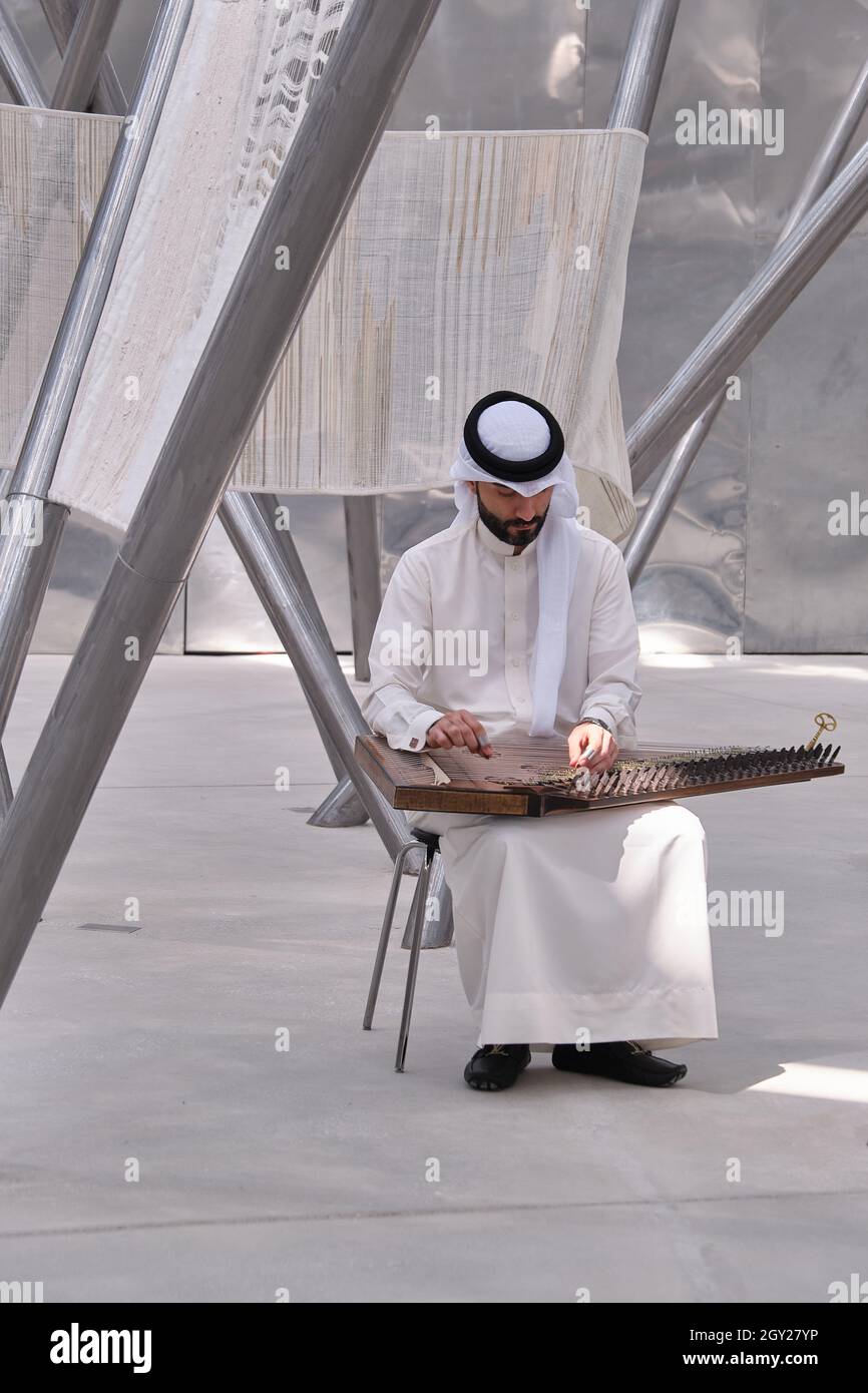 A Bahraini musician playing a box zither inside the Kingdom of Bahrain ...