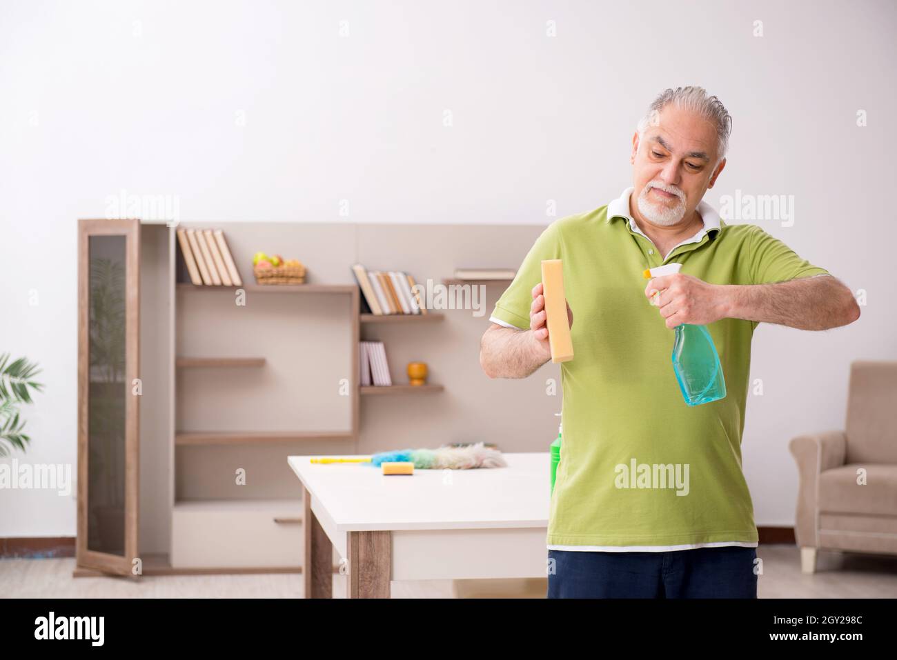 Aged man cleaning the house Stock Photo - Alamy