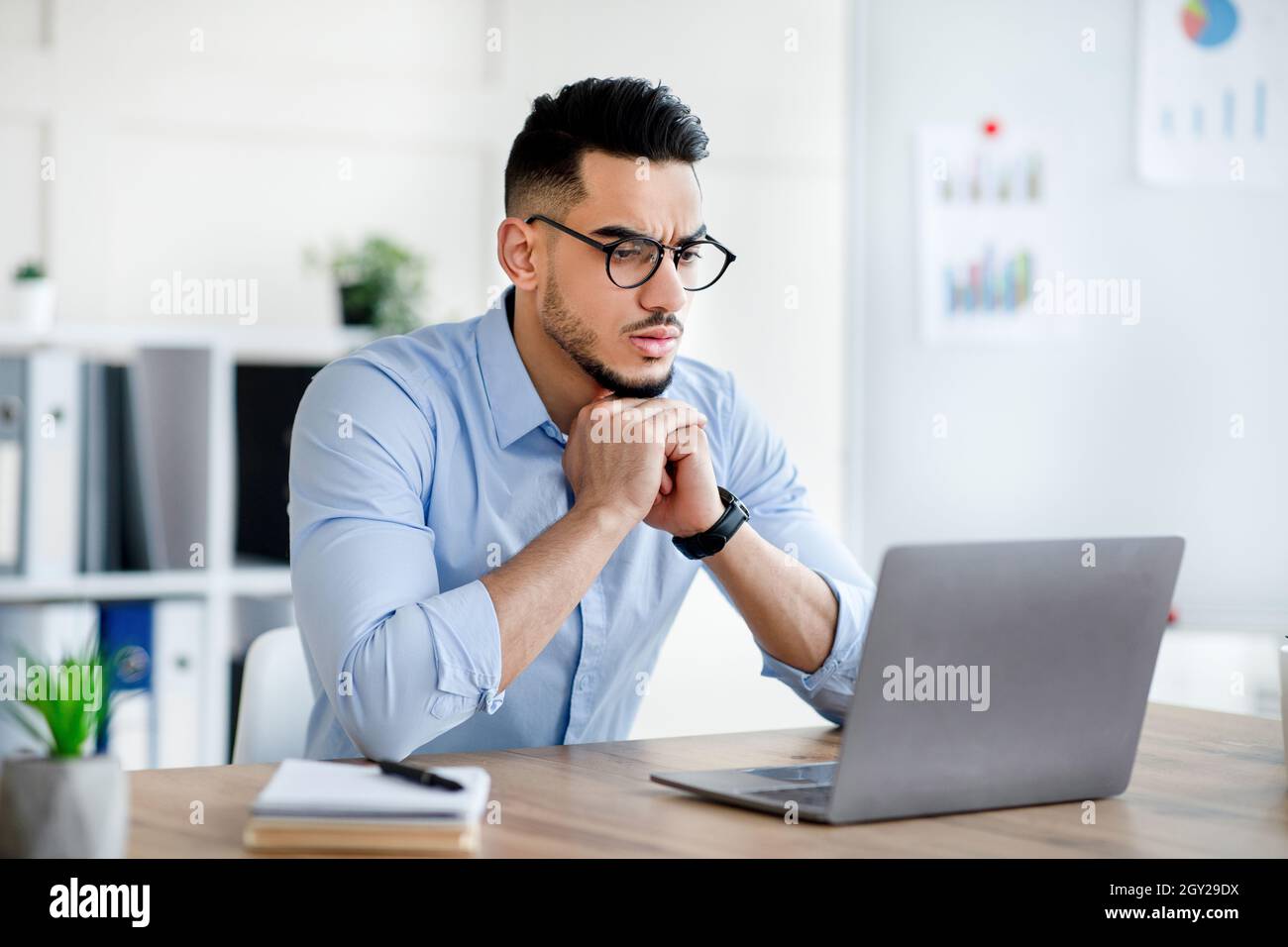 Stressed Arab man using laptop, having problem performing work task ...