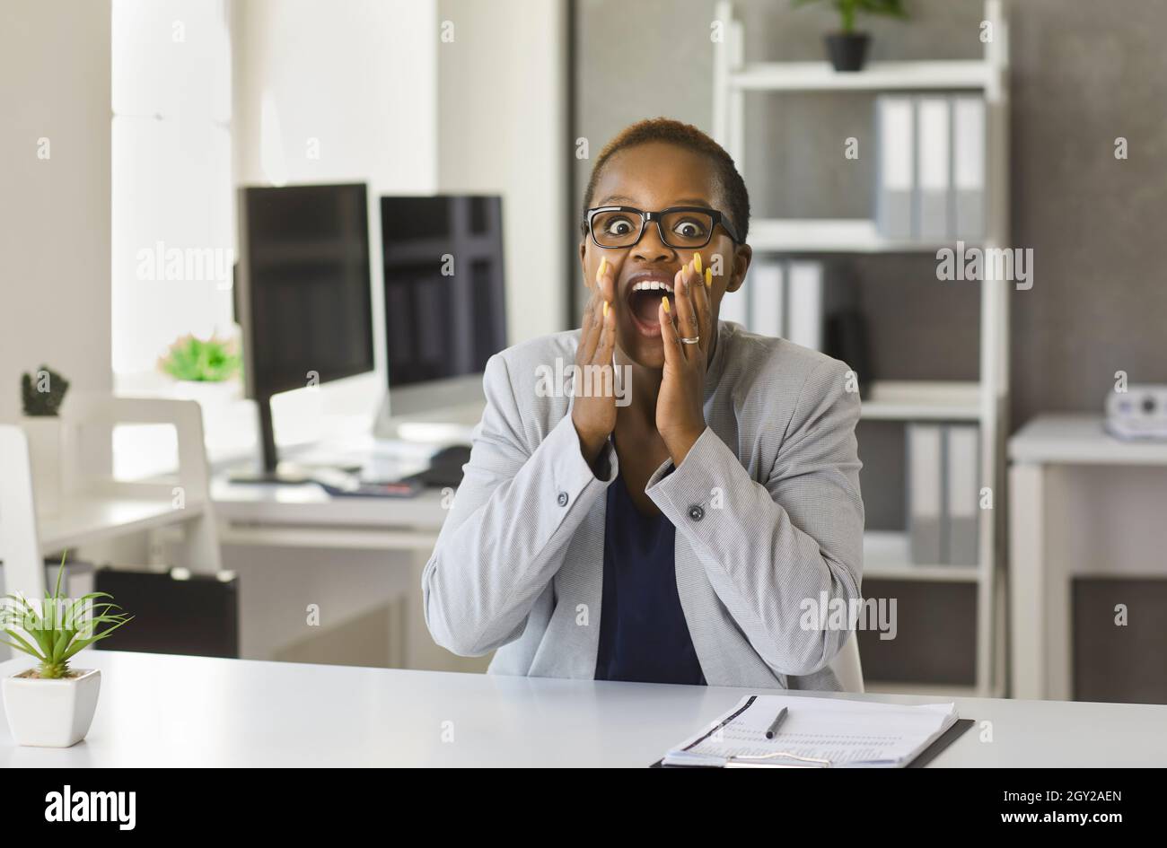Portrait of overjoyed ethnic woman triumph with promotion Stock Photo ...