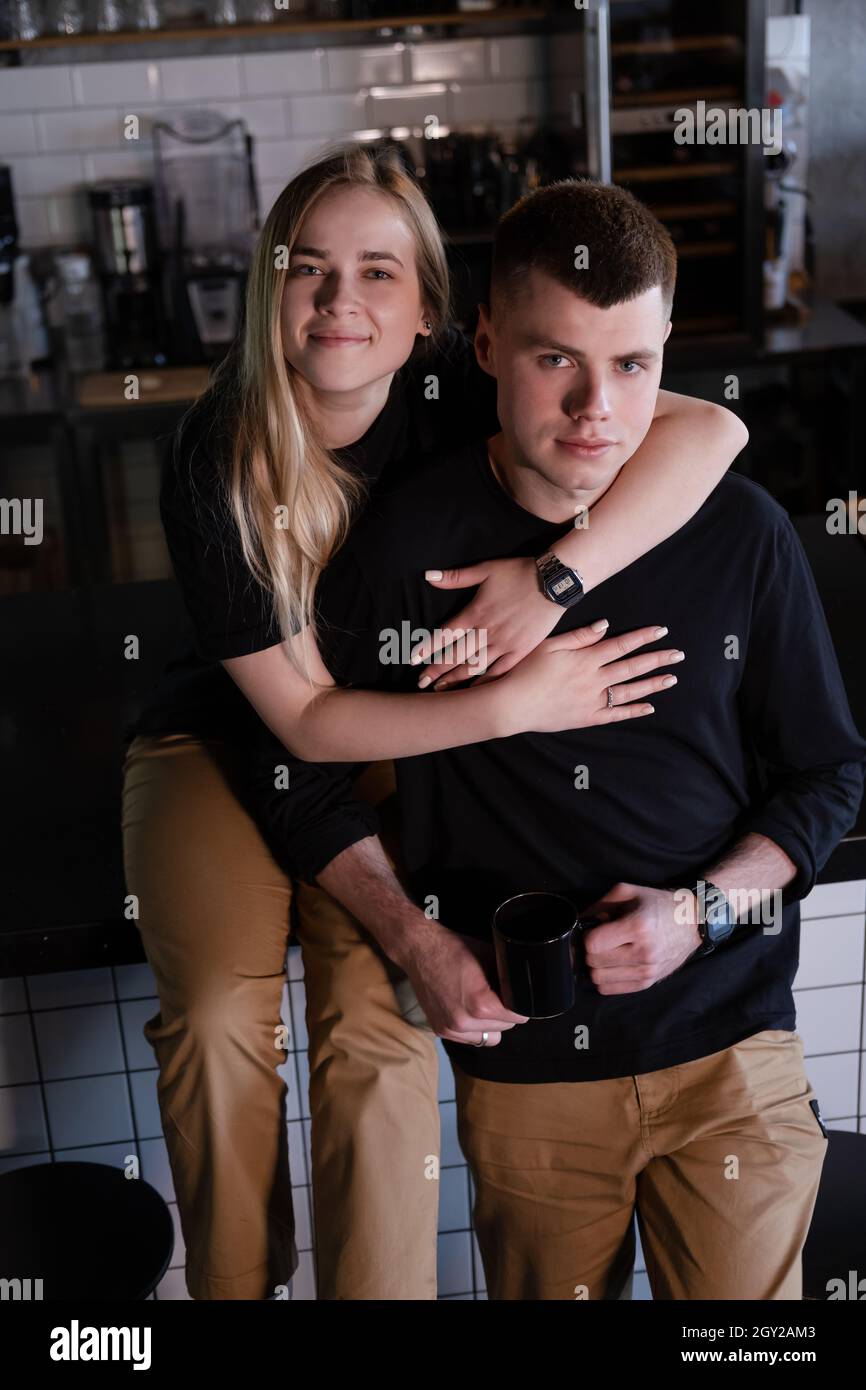 happy married couple in identical clothes family look - cafe owners or ...