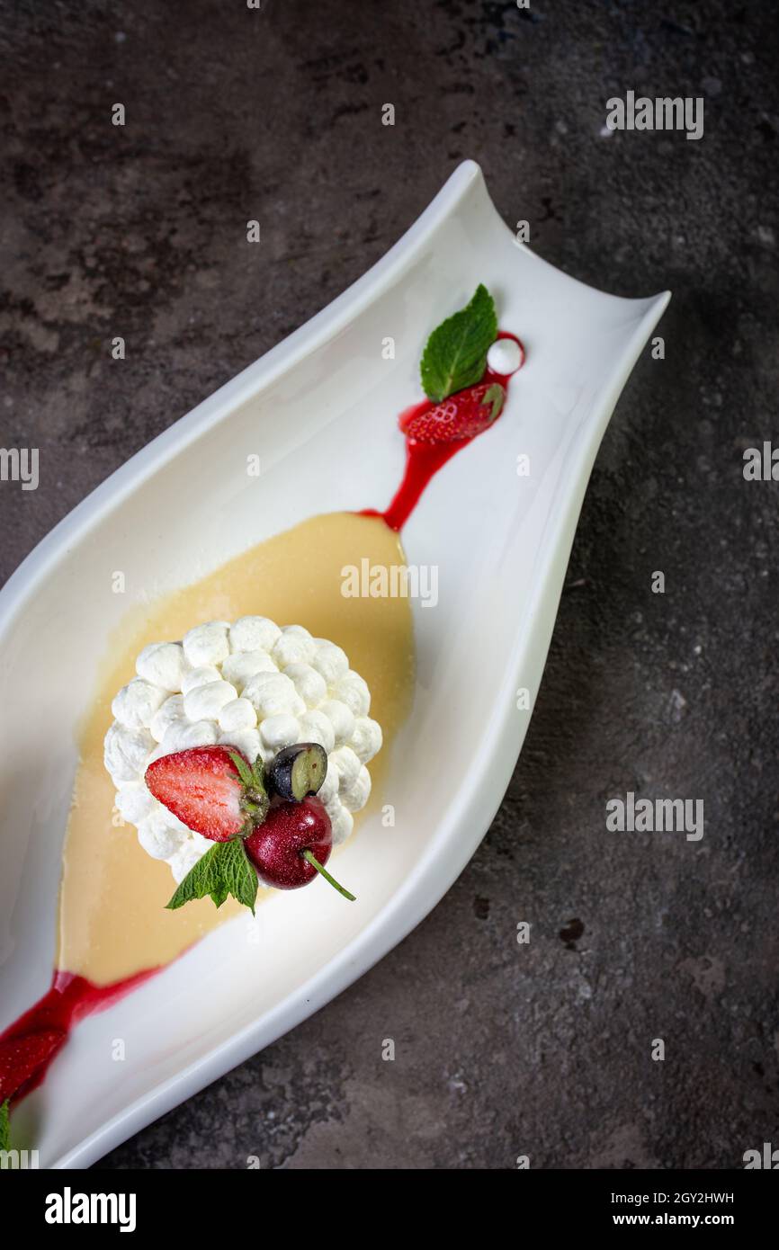 meringue dessert with strawberries in a stylish white plate Stock Photo ...