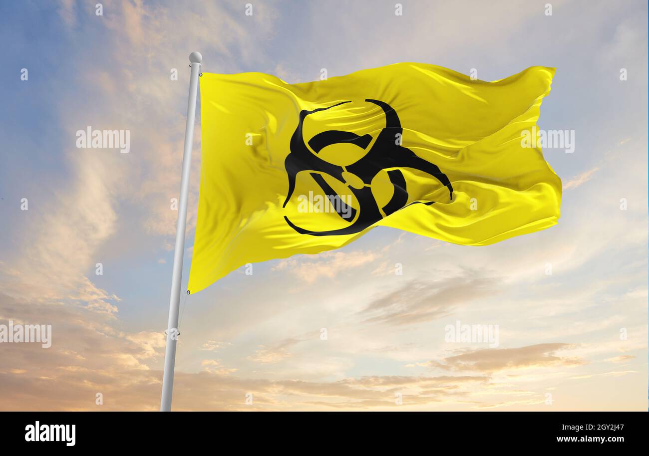 yellow flag of biohazard waving in wind on flagpoles against sky with ...