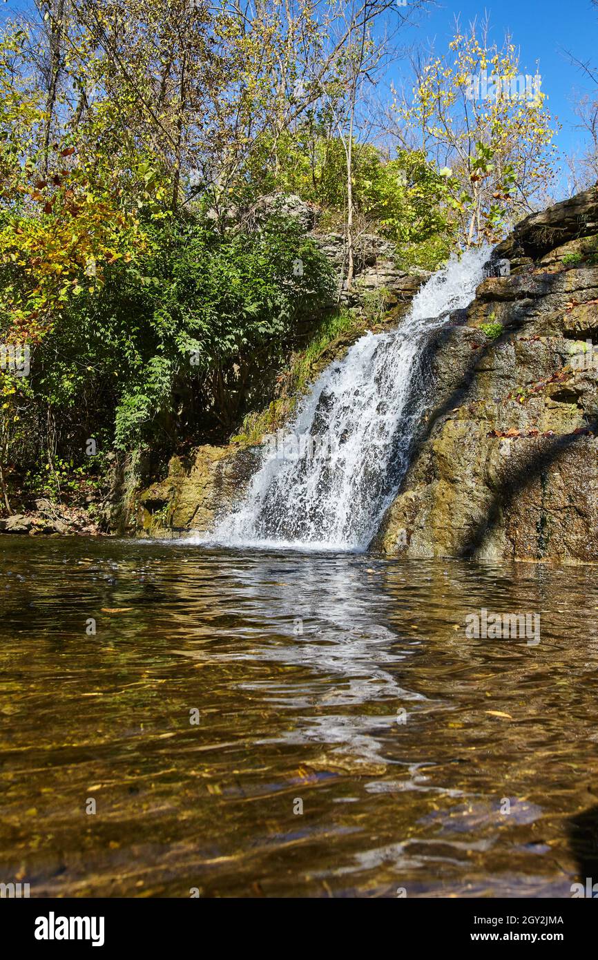 Vertical of waterfall over rocks into small pond low view Stock Photo ...