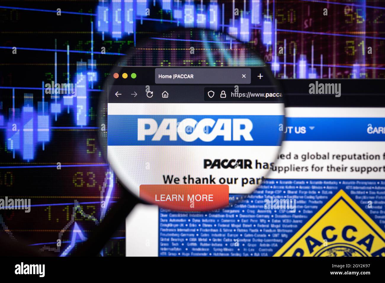 Paccar company logo on a website with blurry stock market developments ...