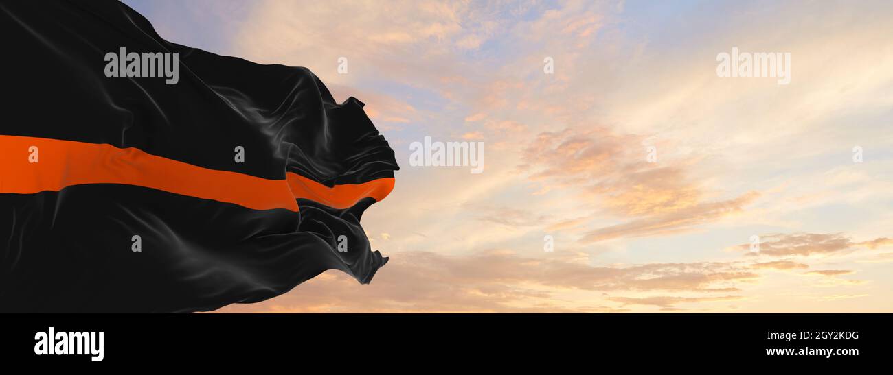 Thin Orange Line flag waving at sky background on sunset, panoramic ...