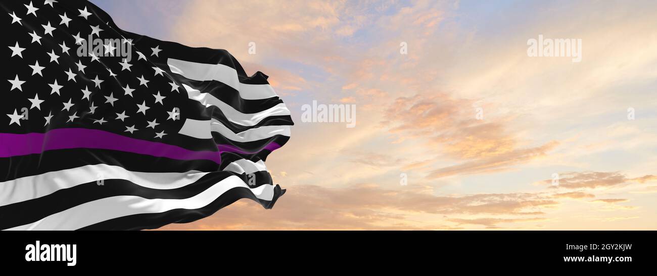 Thin Purple Line USA flag waving at cloudy sky background on sunset ...
