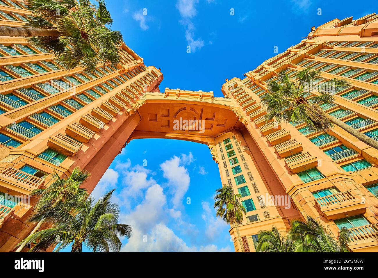 View of tall hotel for tourists in the tropics next to palm trees Stock ...