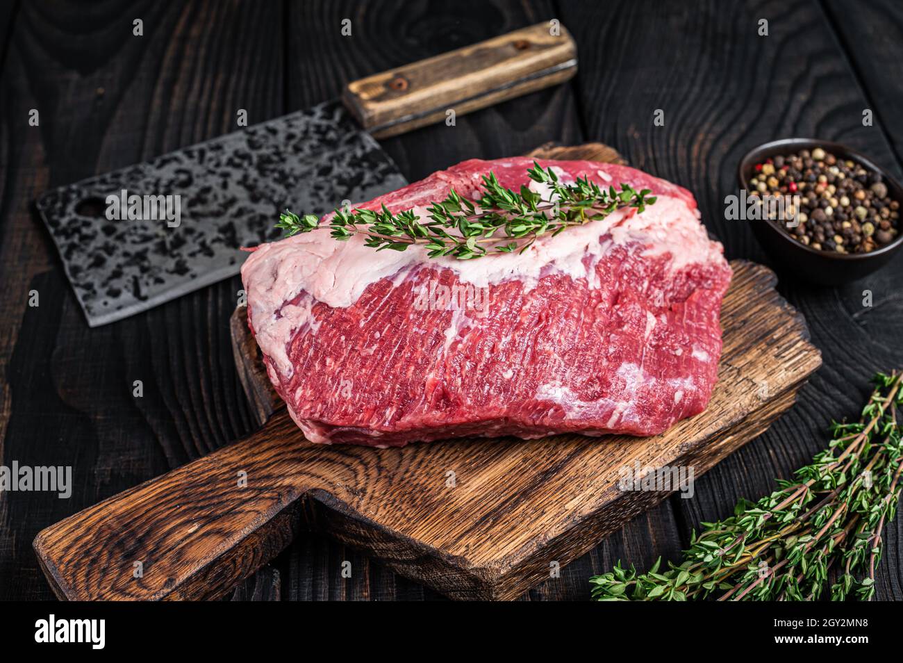 Fresh Raw Round roast beef meat cut on a butcher cutting board with ...