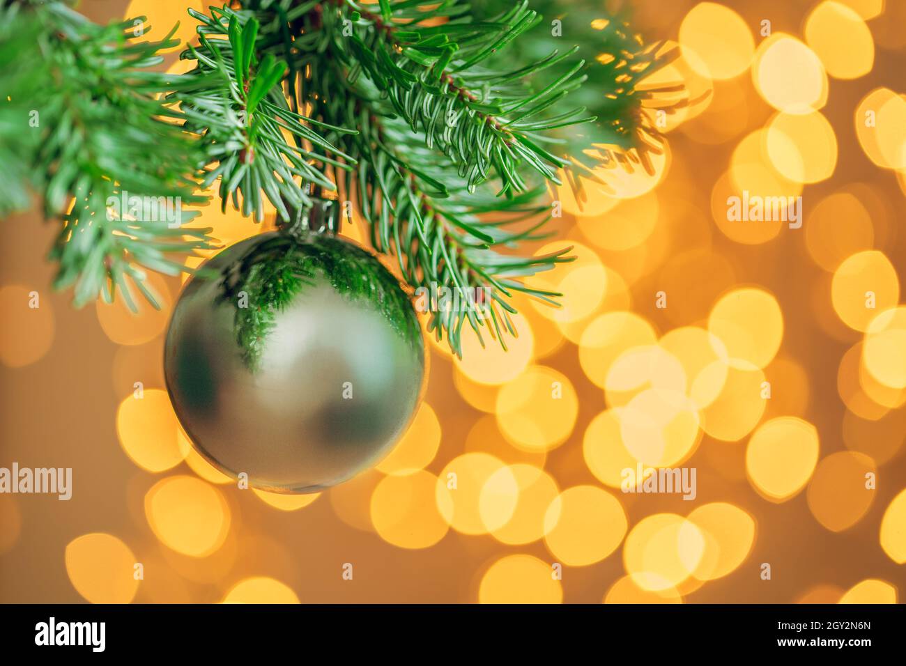 Christmas tree background with golden bauble on bokeh sparkling Stock Photo - Alamy