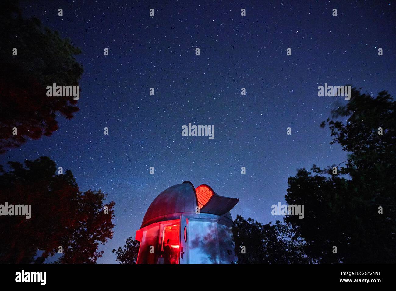 Observatory open to the night sky with red light coming from it ominous ...