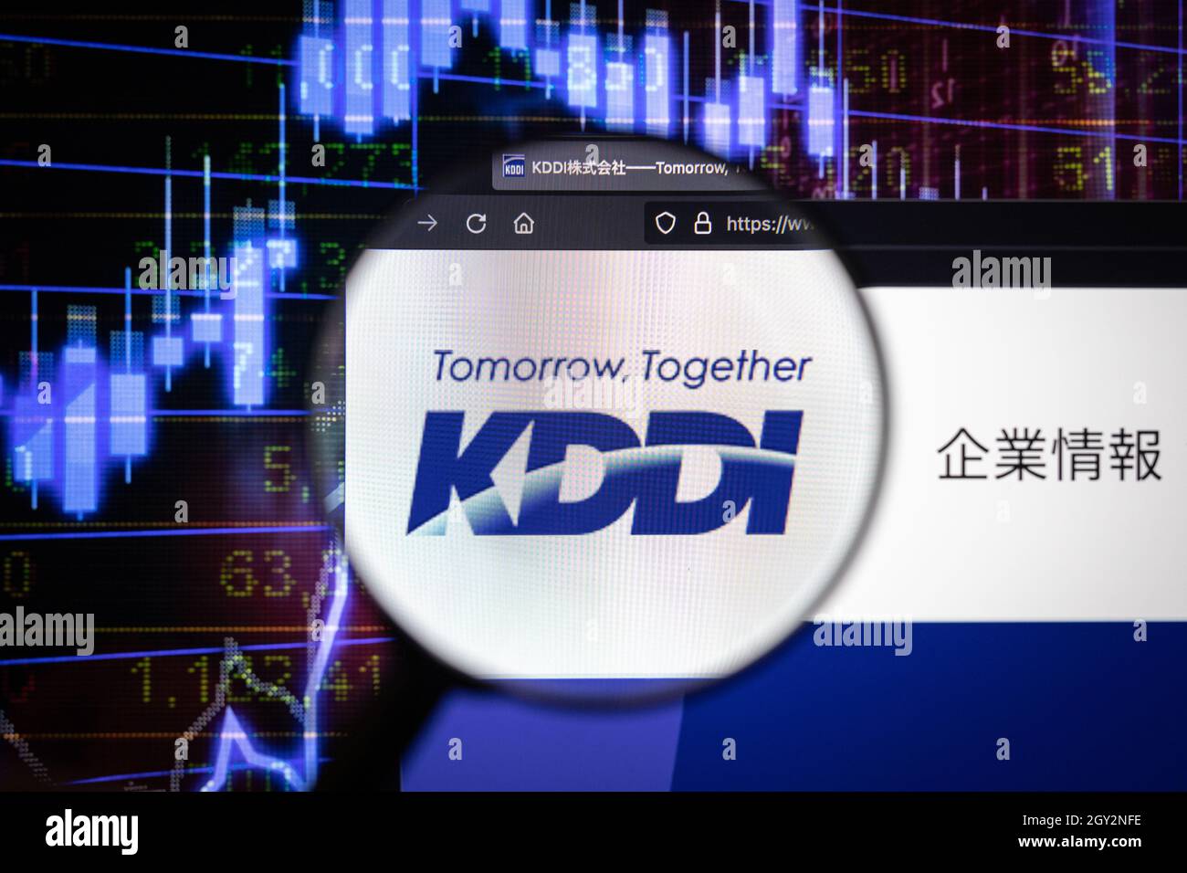 KDDI company logo on a website with blurry stock market developments in the background, seen on ...