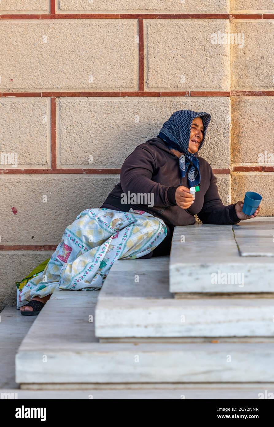 old greek lady begging on the steps of the town miracle church in zante ...