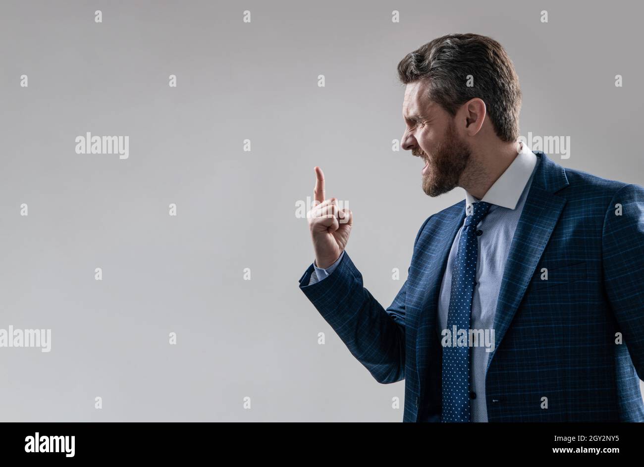 Angry broker man in formal wear sideway keep finger raised grey ...