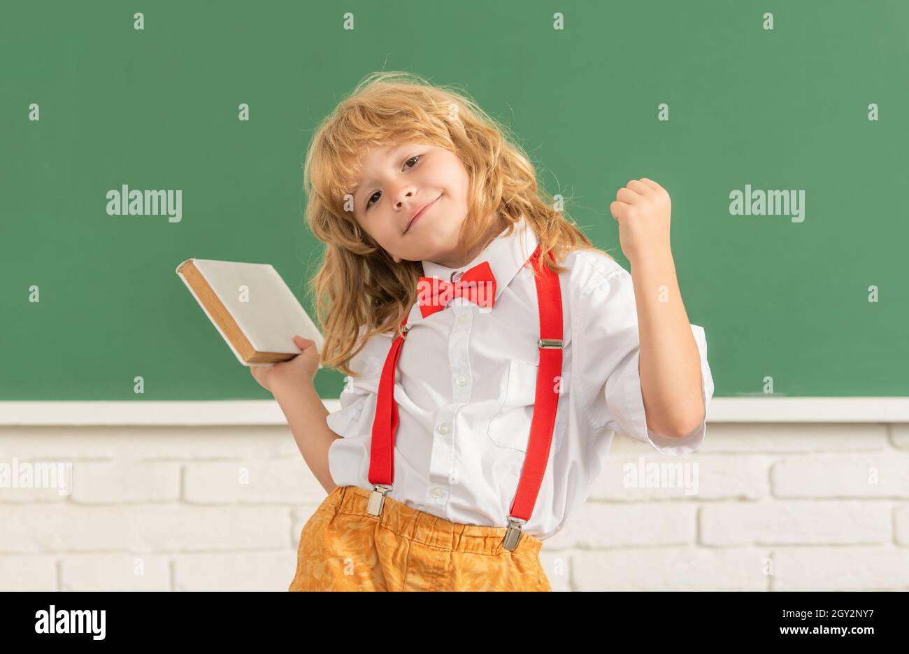 nerd kid with long hair at blackboard. september 1. childhood ...