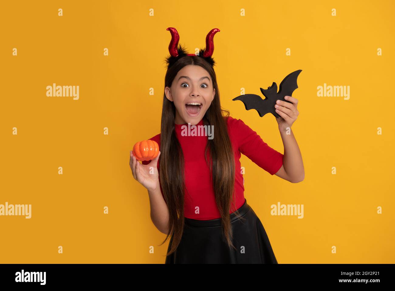 celebrate autumn party holiday. childhood fun. amazed evil child in imp ...