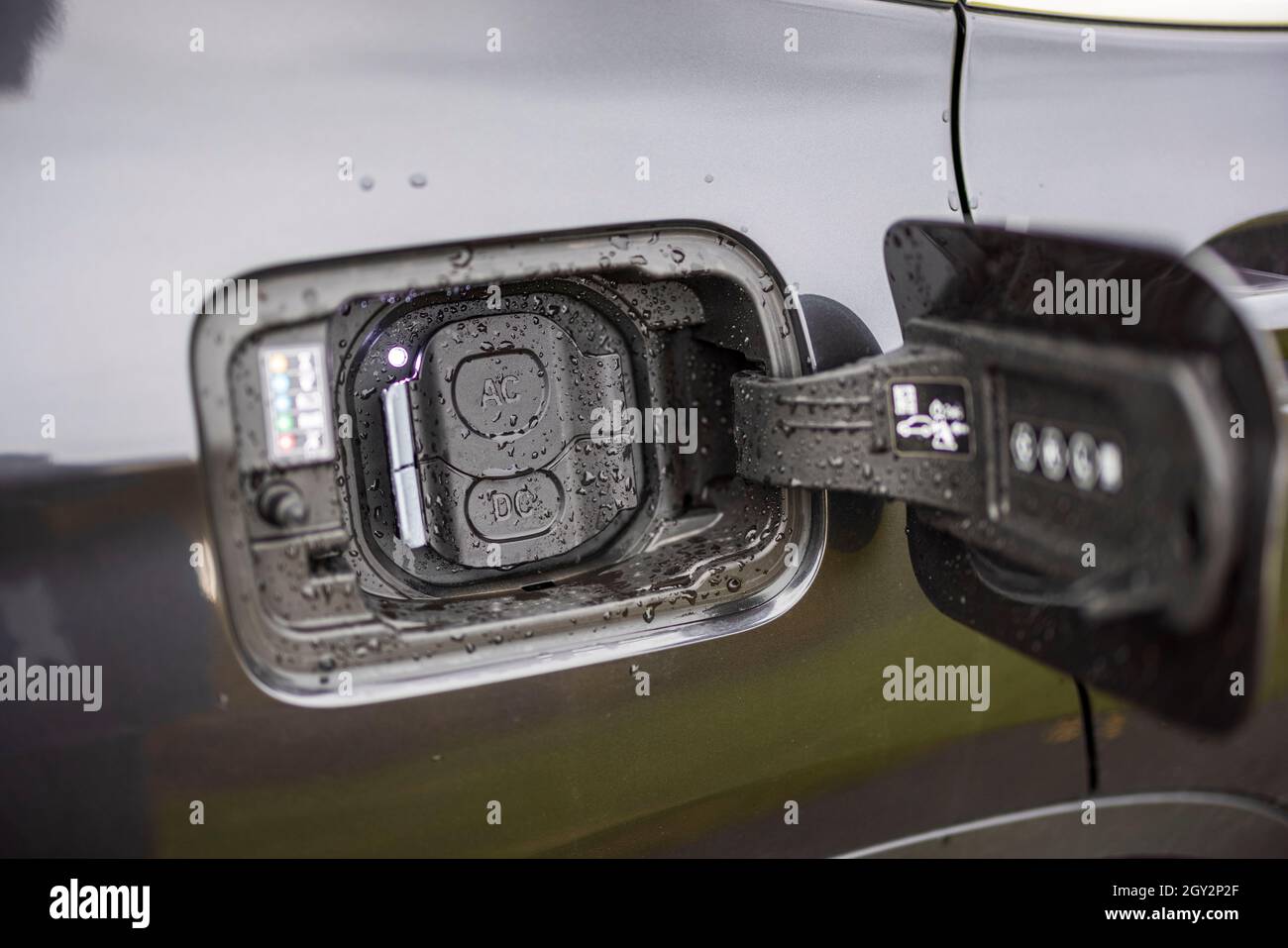 Close up view of an open hatch in an electric car for charging it ...