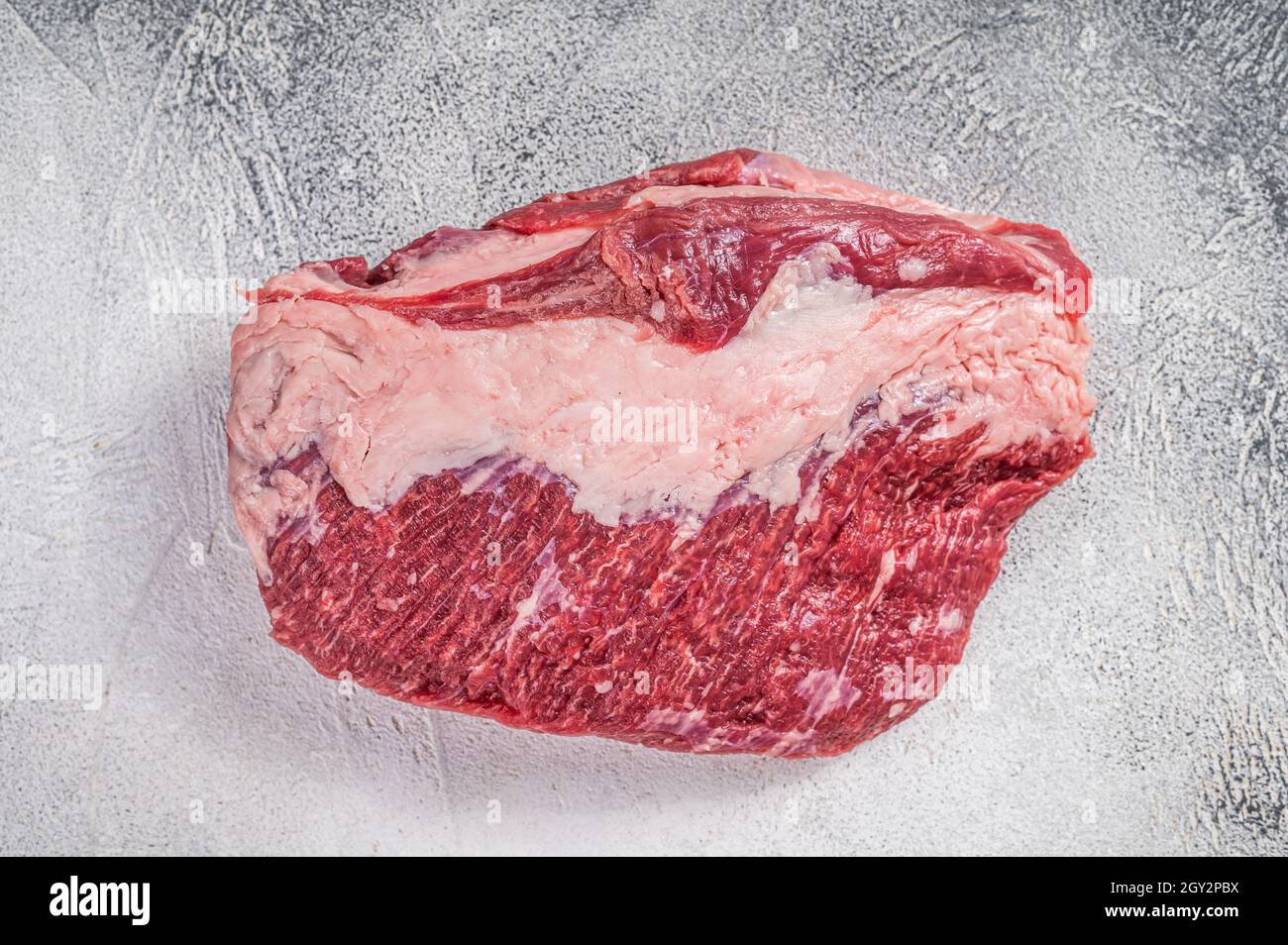 Raw Round beef meat cut on a butcher table. White background. Top view ...