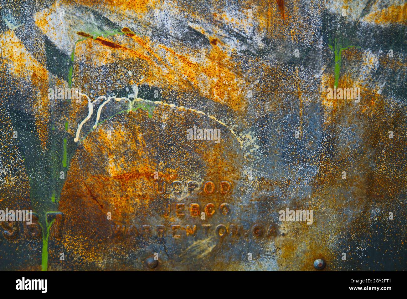 Rusty old metal plaque with letters and numbers embossed on it ...