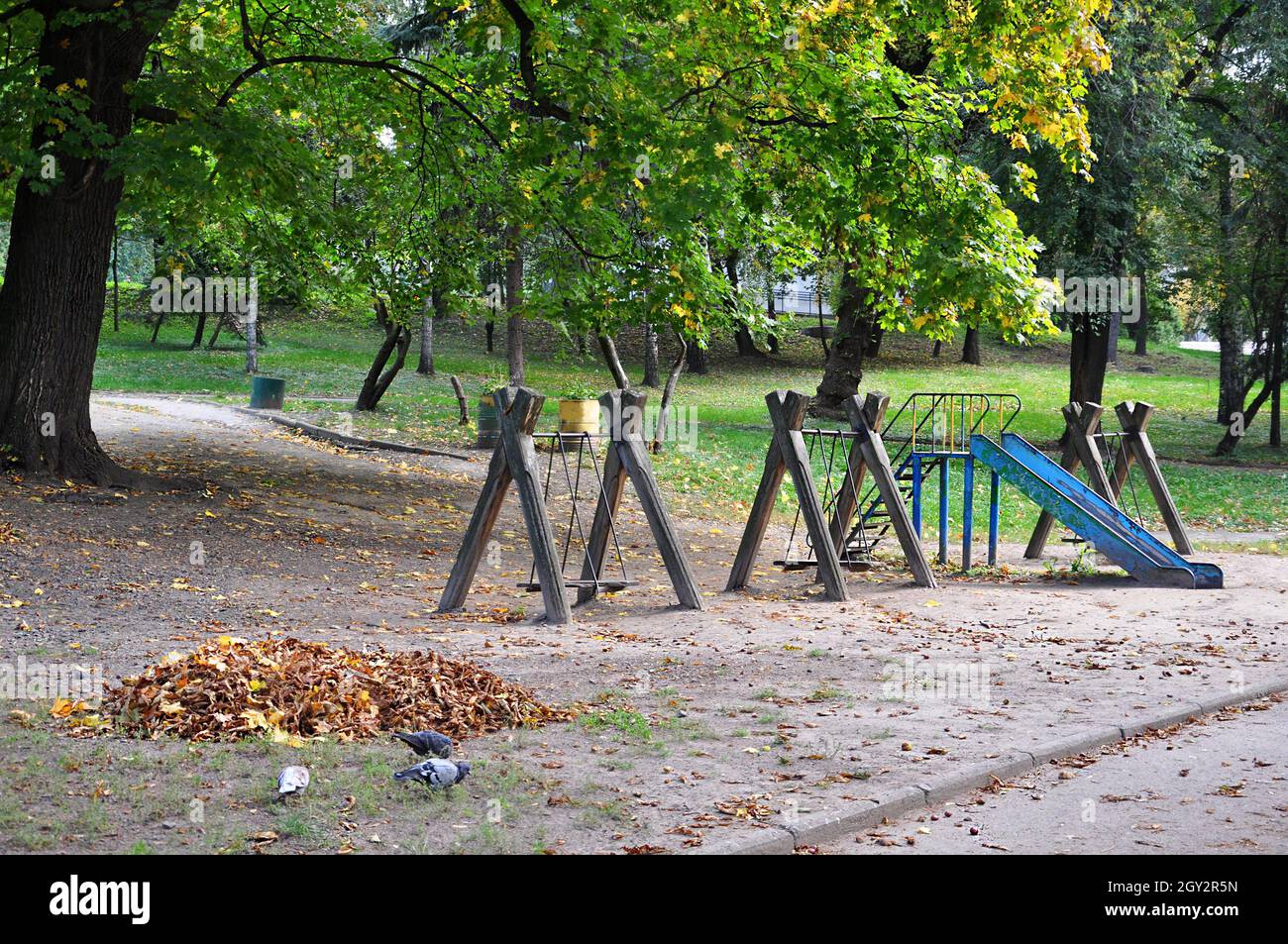 Old and rusty empty playground in the municipal park with autumnal ...
