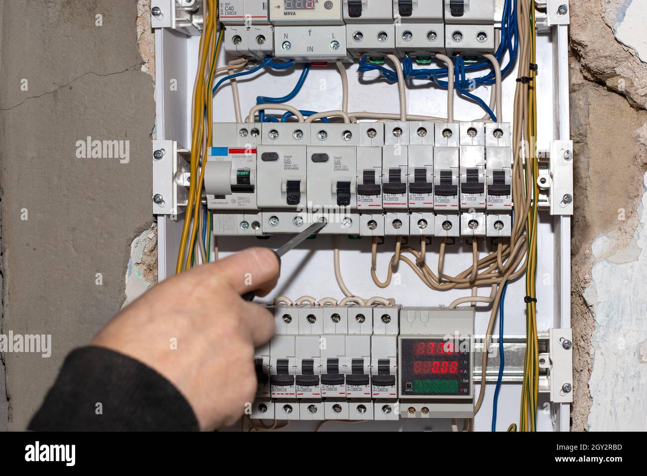 Electrical switchboard. A electrician installs a multifunctional shield ...