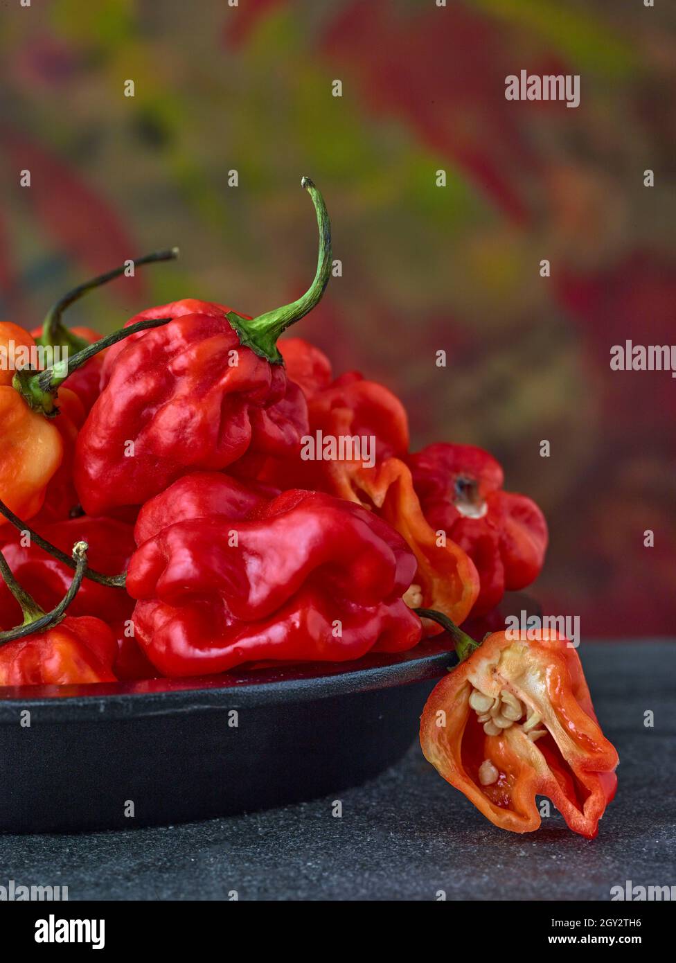 Moody low key food still life of Scotch bonnet peppers Stock Photo - Alamy