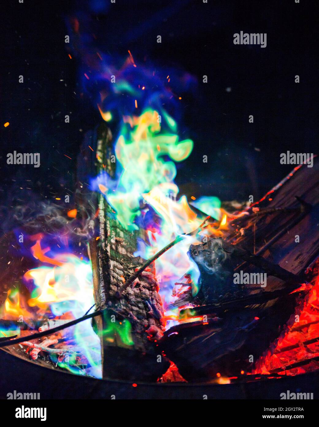 Rainbow and iridescent flames rage in a fire pit Stock Photo - Alamy