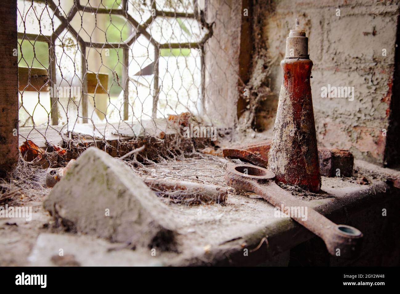 Dust covered items on a windowsill in an abandoned and derelict ...