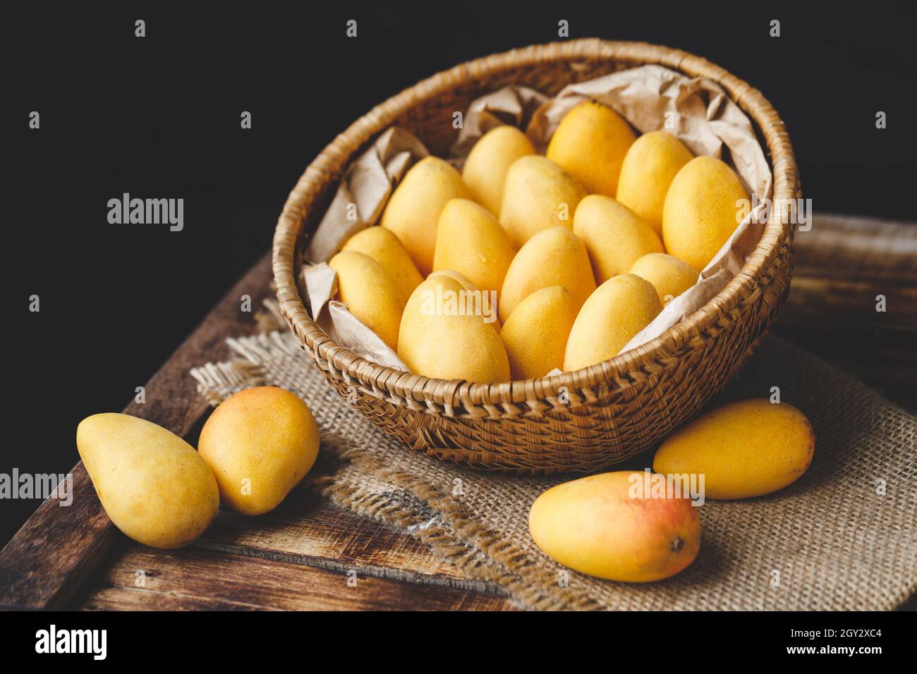Mangoes in wooden basket hi-res stock photography and images - Alamy