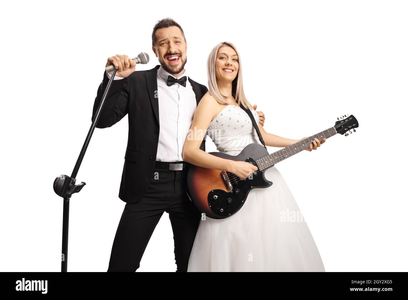 Beutiful bride playing a guitar and groom singing on a microphone ...