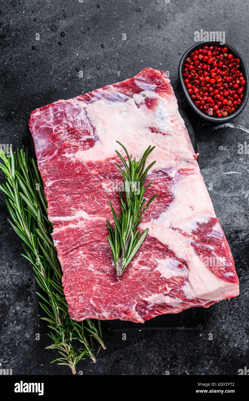 Raw beef short ribs kalbi on marble board. Black background. Top view ...