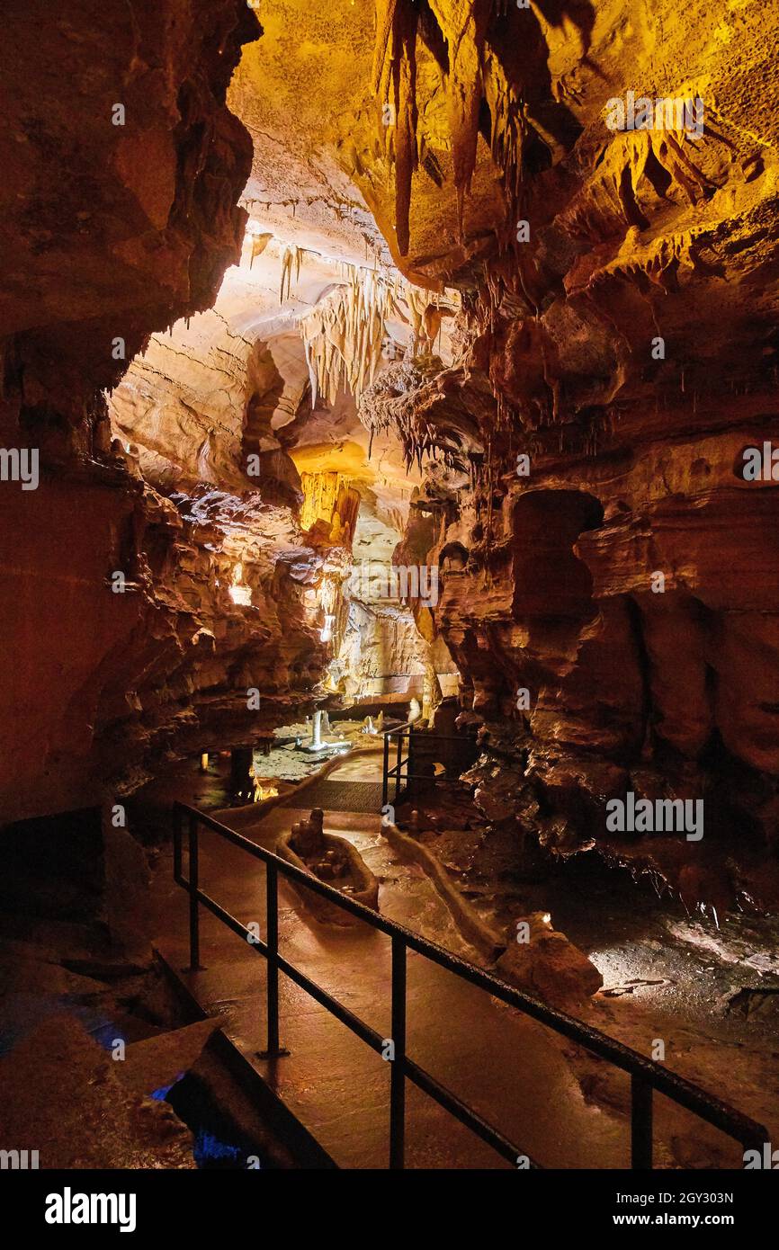 Tour path through underground cave in Indiana with rock formations ...