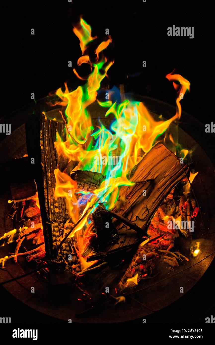 Red green and yellow flames rage in a fire pit Stock Photo - Alamy