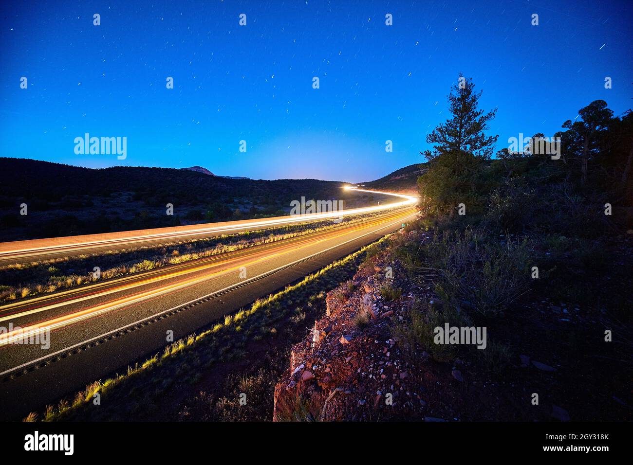 Time lapse long exposure shot of traffic streaking across a road Stock ...