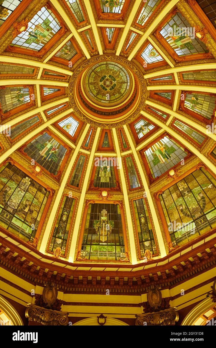 Multicolored and rococo ceiling with small stained glass windows with ...