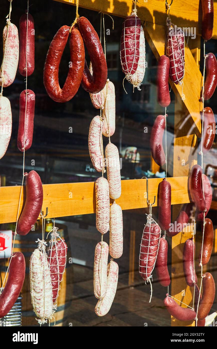 Butcher shop with fresh and colorful sausages hanging in window Stock ...