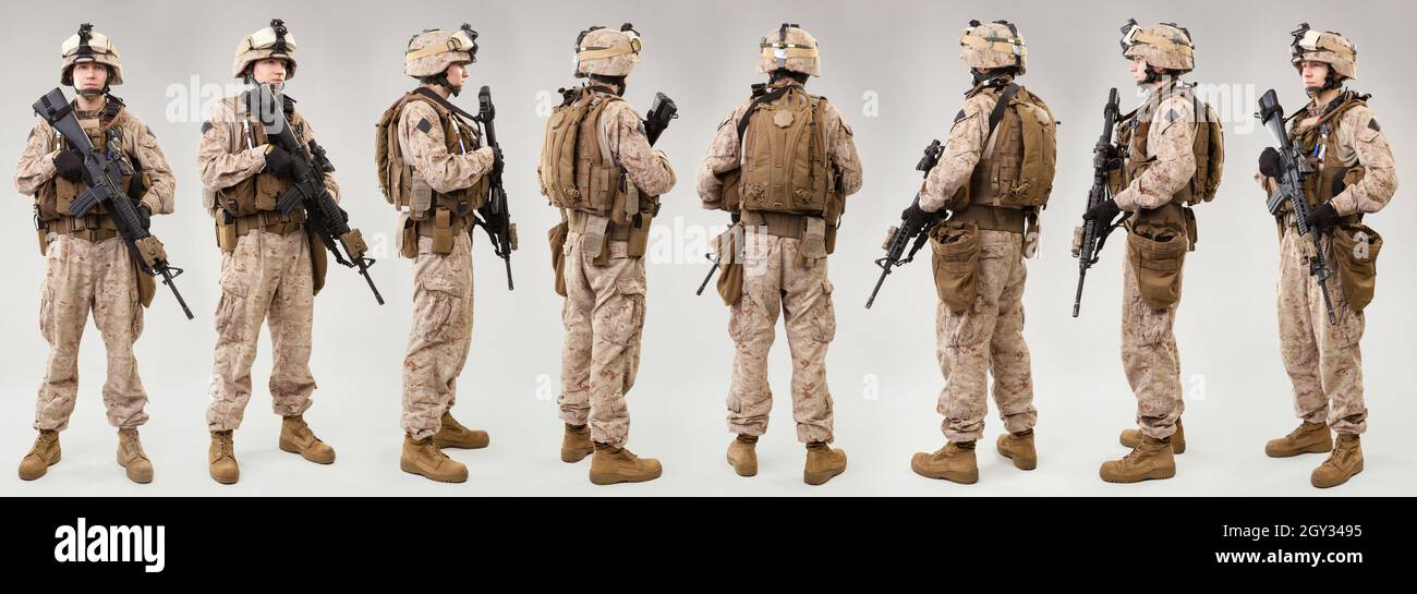 US marines forces soldiers with rifles on grey background. Shot in ...