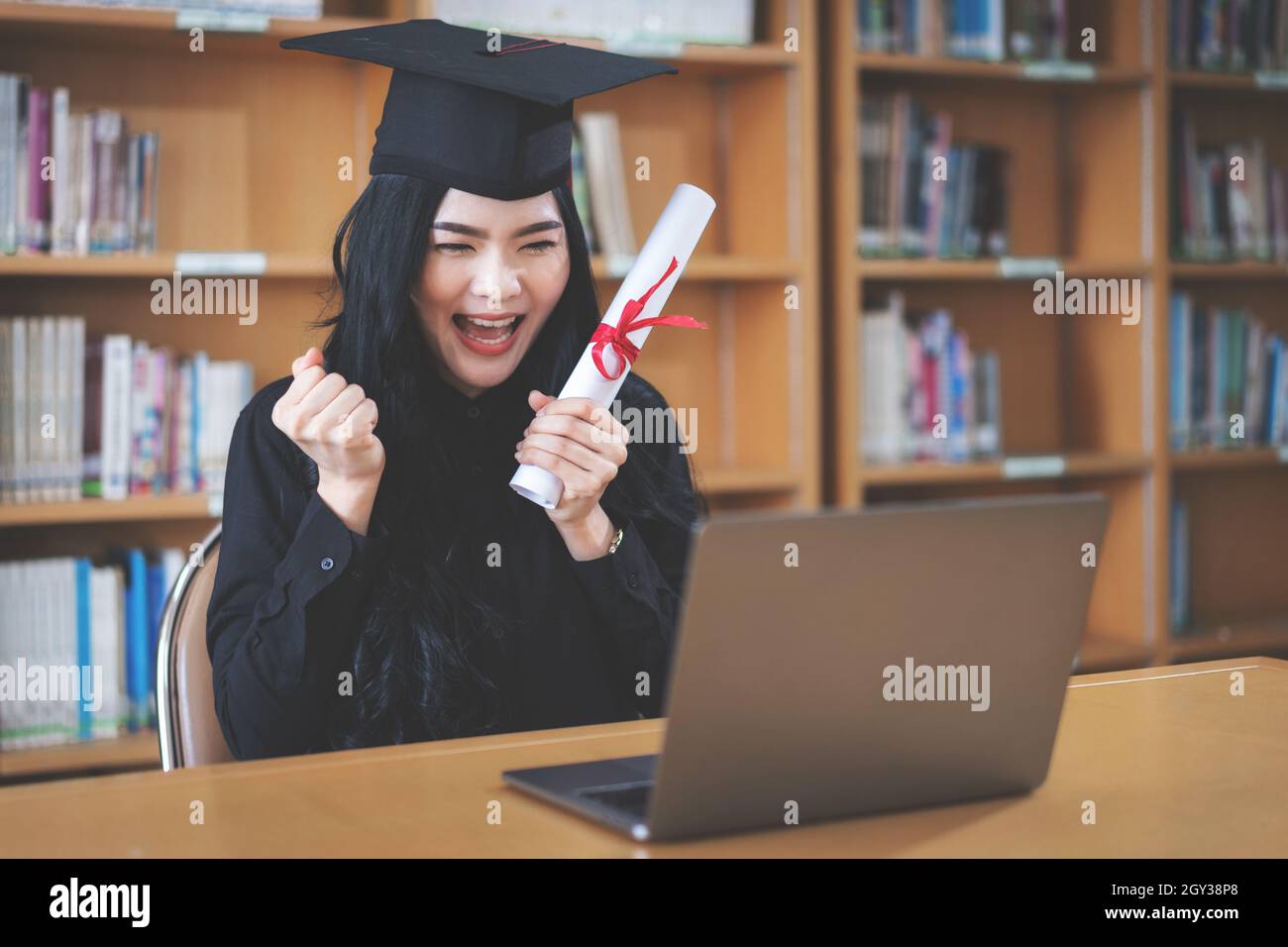 Young university student expressing joy and excitement for graduation ...