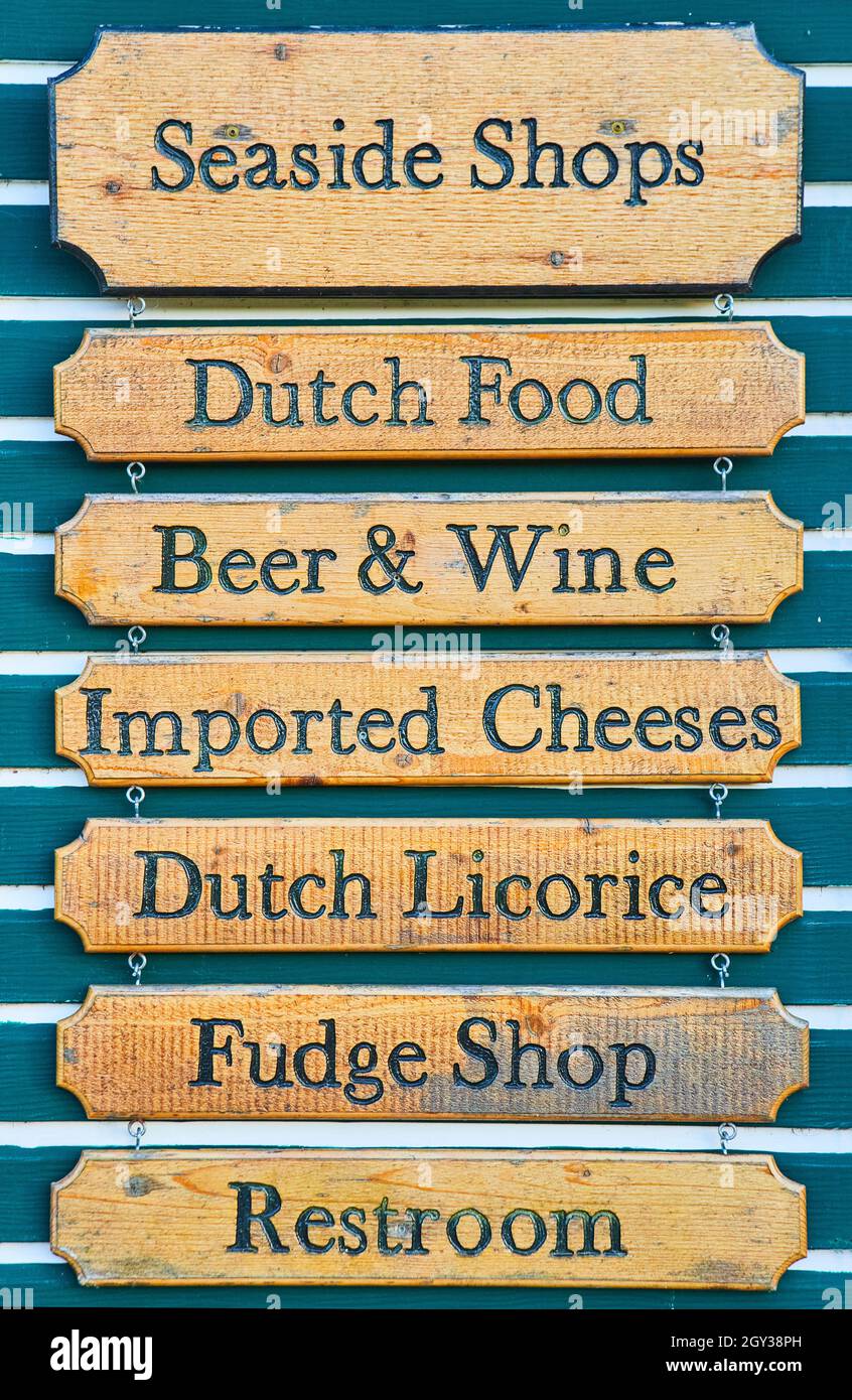 Old wall of signs in dutch shopping center on blue wall Stock Photo - Alamy