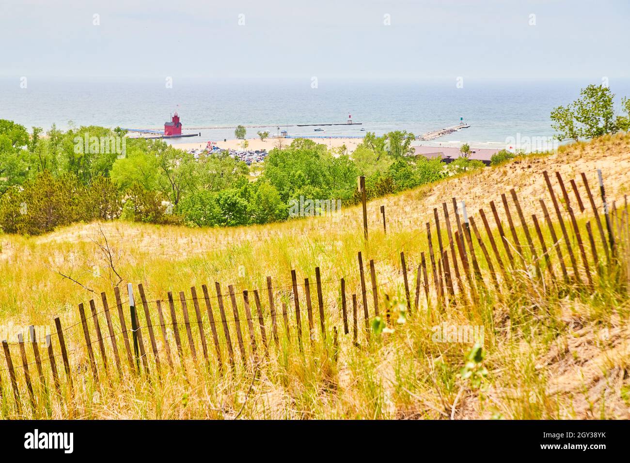 Sand dunes in Michigan with view of red lighthouse and great lake in ...