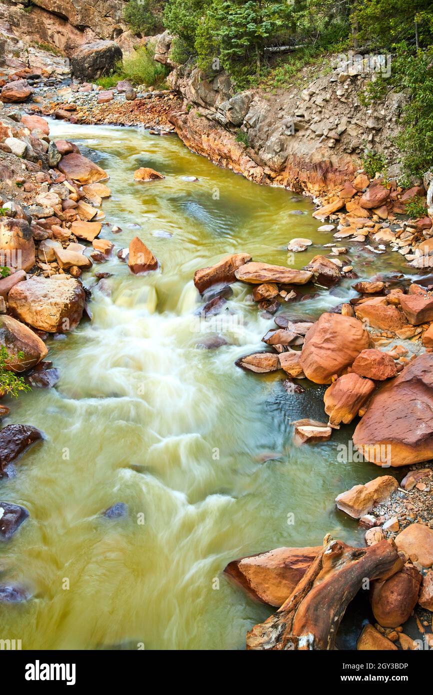 River filled with mineral water lined with red rocks Stock Photo - Alamy