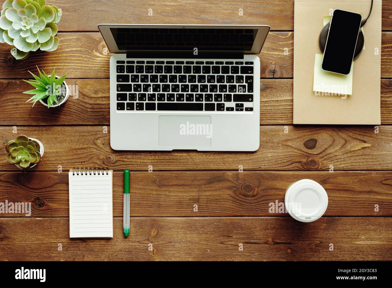 Office table workspace top view. Wooden desk with laptop, devices and ...