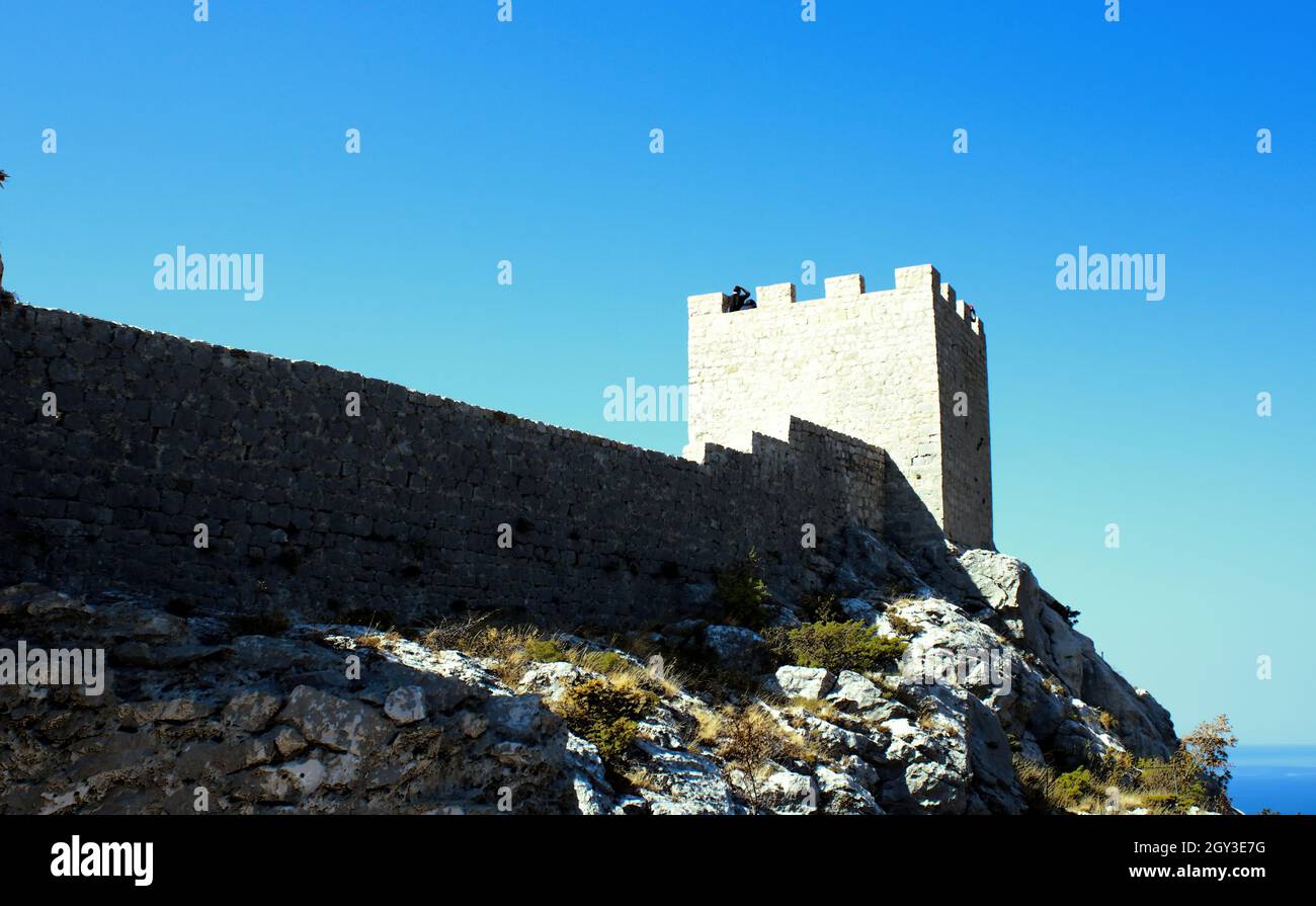 Low-angle shot of a medieval brick building with gates on the rock ...