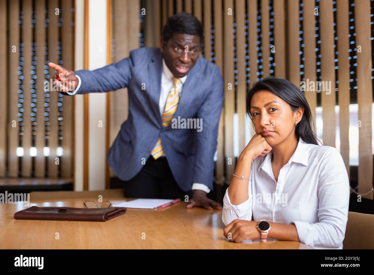 Angry boss blowing up female subordinate for mistakes Stock Photo - Alamy