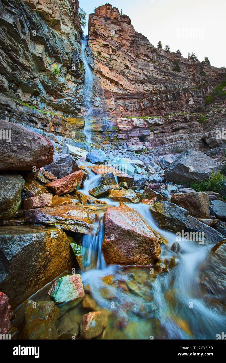 View of large waterfalls plummeting over cliff into pile of rocks with ...