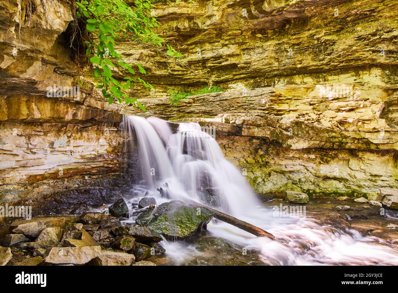 View from side of waterfall splashing off of cliff surface in canyon ...