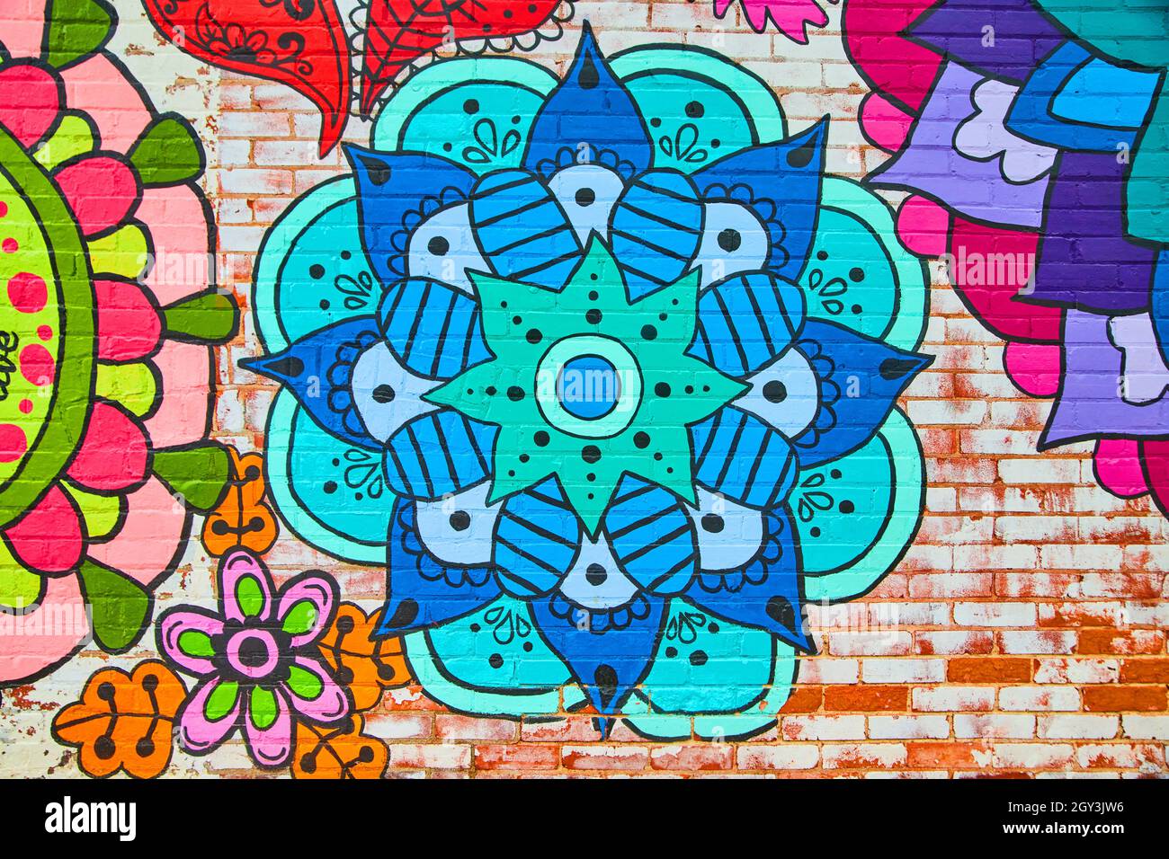 Brick wall with mural of colorful flower patterns Stock Photo - Alamy